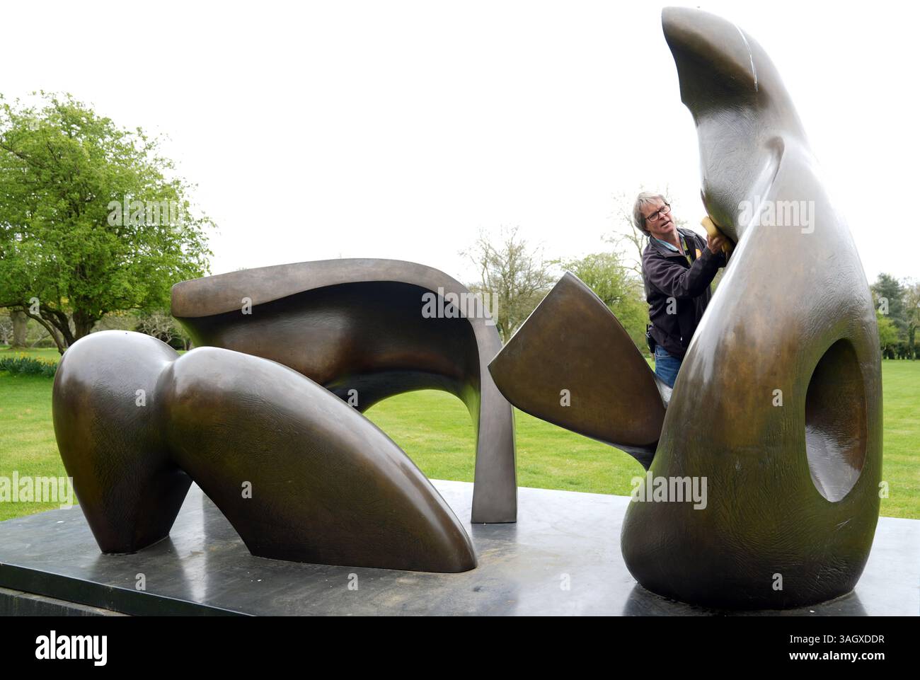 Art technician Matthias Kessemeier cleans the bronze sculpture 'Three Piece Reclining Figure ...