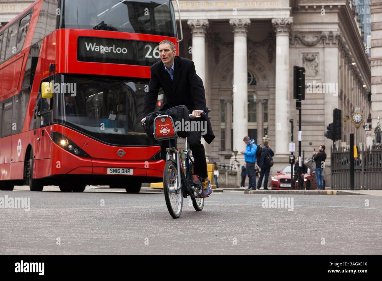 Cyclist and double decker London bus in the city's financial district Stock Photo - Alamy