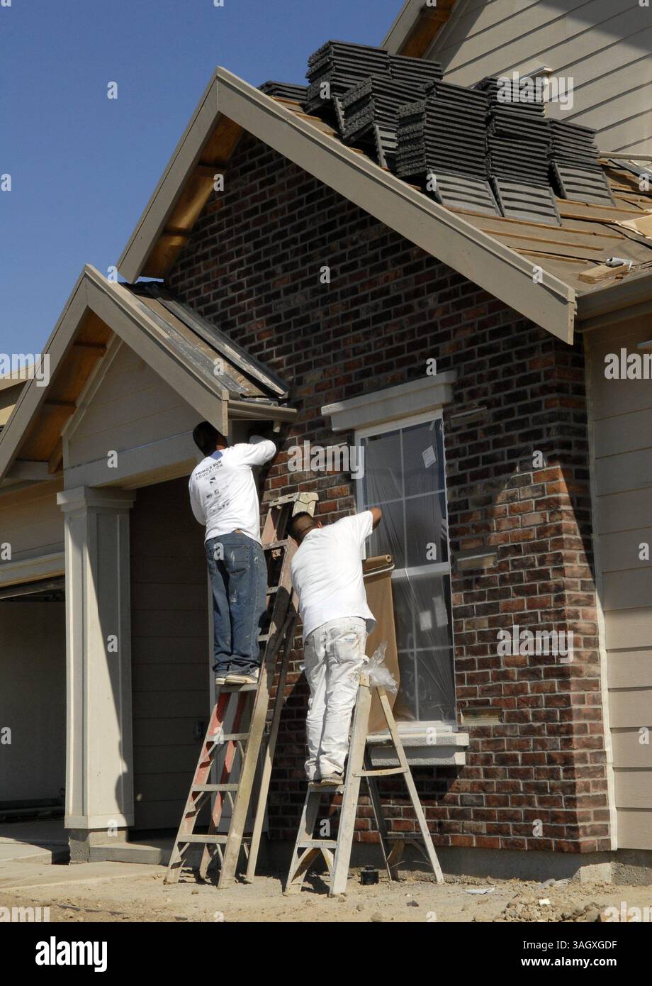 Painters prepare the exterior for painting at this home on Cinnamon ...