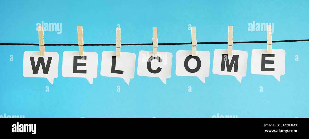 Welcome word and sign on white paper speech bubbles hanged on blue ...
