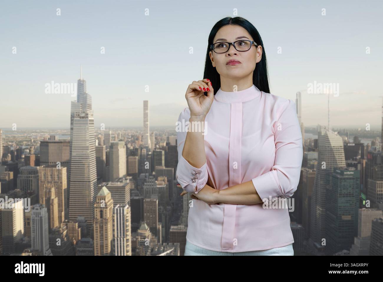 Young asian woman standing outdoors and thinking. Urban city scape ...