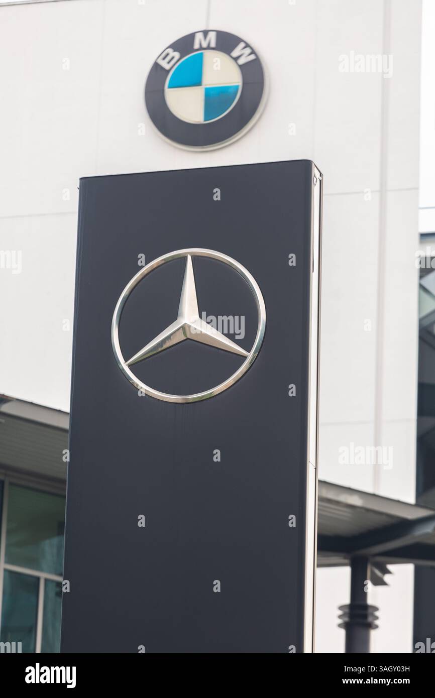 Vertical view. Silver arrow Mercedes and BMW logo and signage to lure ...