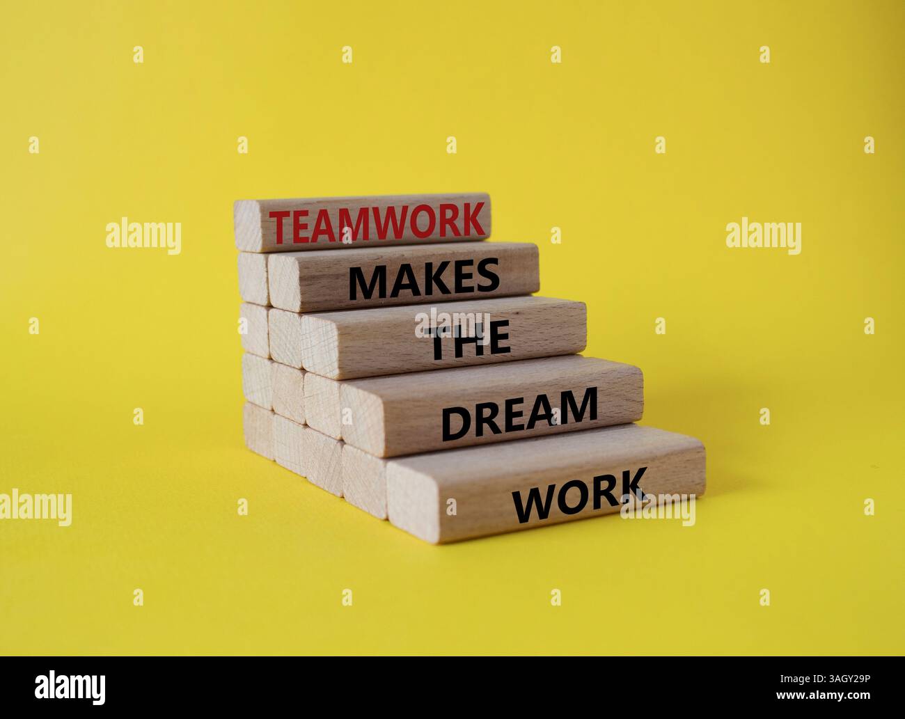 Teamwork symbol. Wooden blocks with words Teamwork makes the Dream work ...
