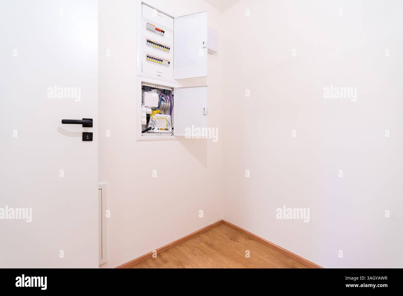 Modern electrical and network distribution panel with open doors in a ...