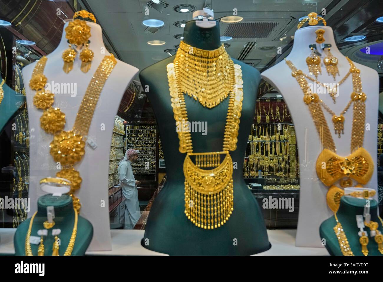 A shopkeeper waits for customers as jewelry is displayed at a jewelry ...