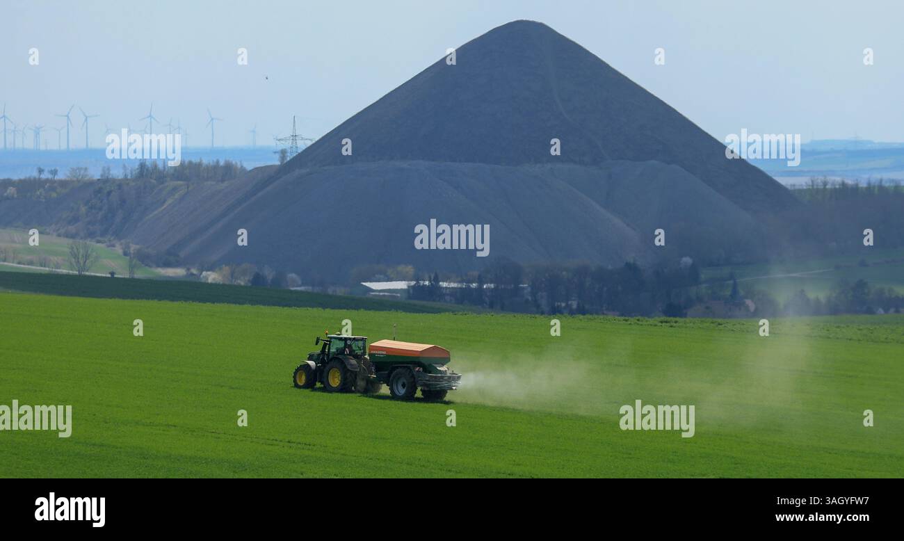 09 April 2025, Saxony-Anhalt, Mansfeld: A farmer cultivates his field ...