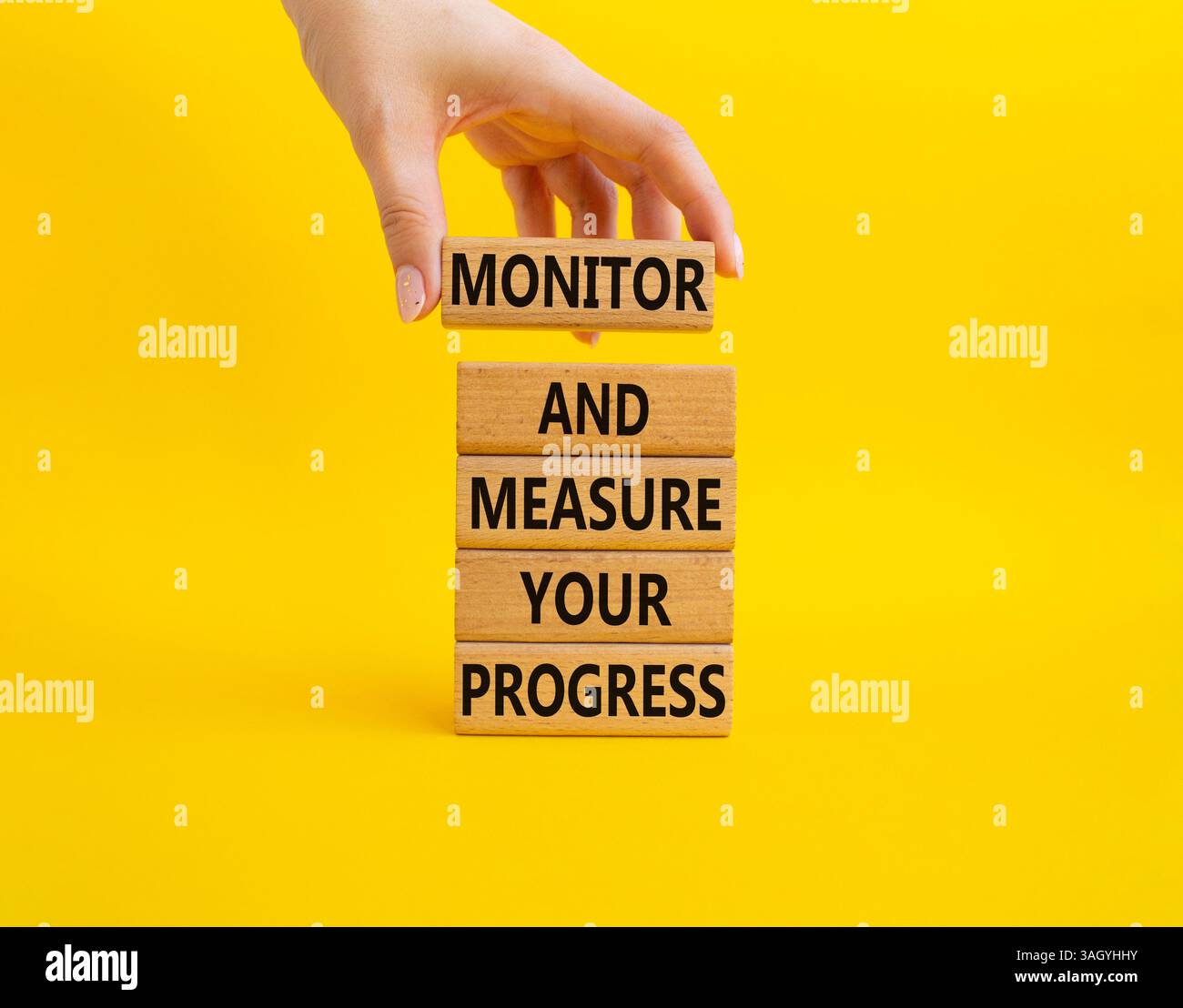 Monitor and Measure your Progress symbol. Wooden blocks with words ...