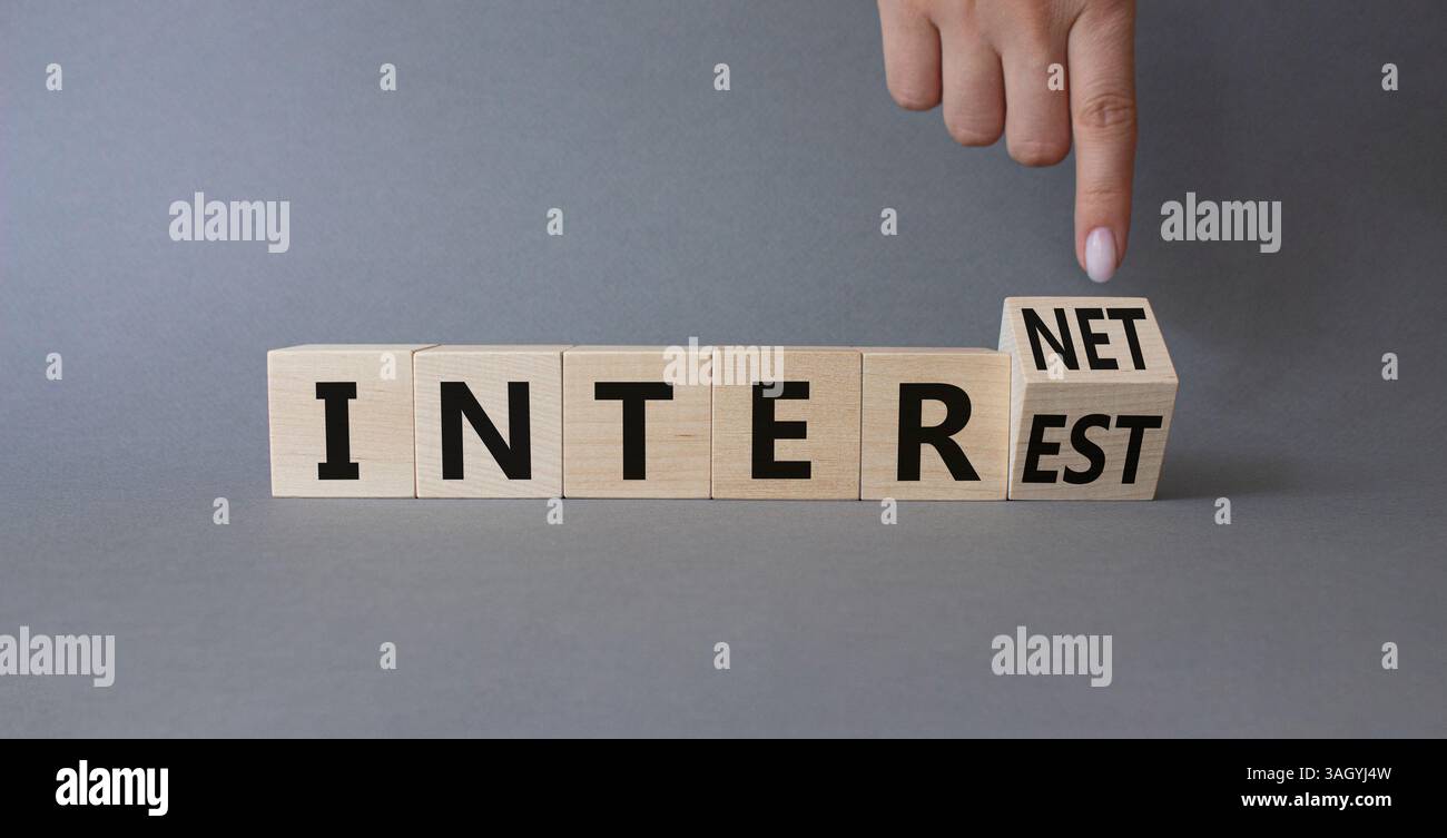 Internet and Interest symbol. Businessman Hand points at wooden cubes ...