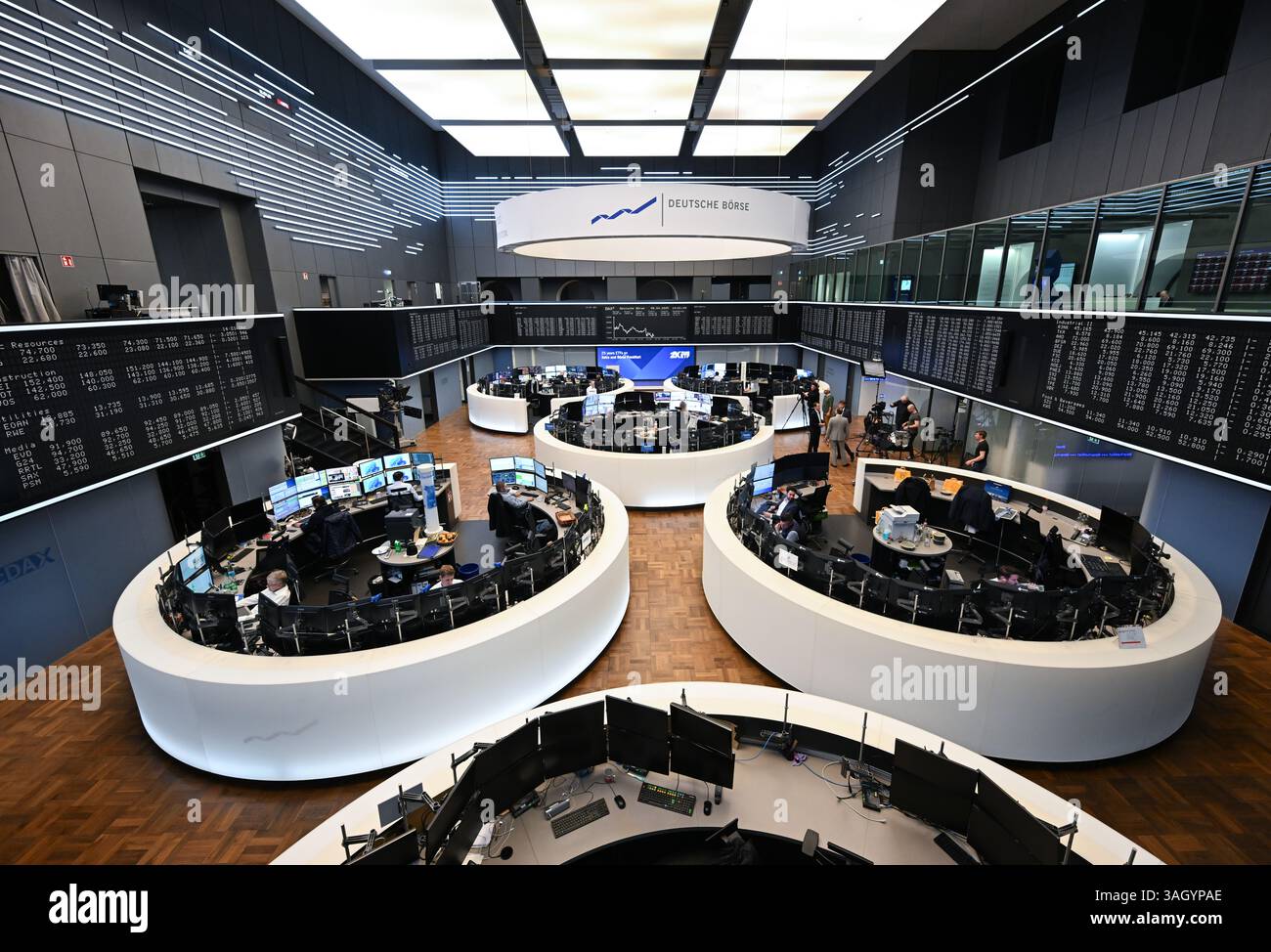 09 April 2025, Hesse, Frankfurt/Main: Stock exchange traders sit on the ...