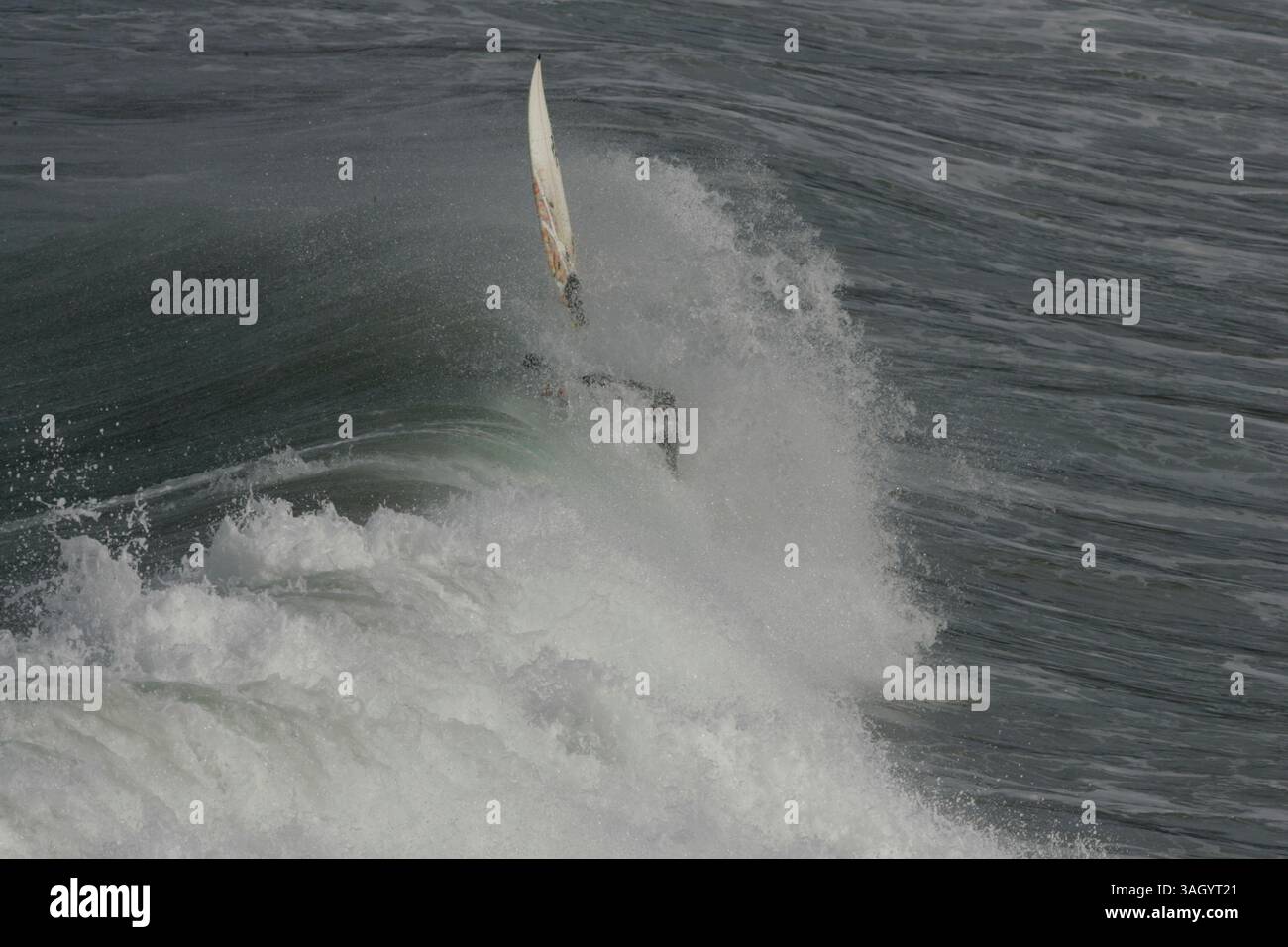 A waveski pops up over the surf break in Punta Cabras, Baja California ...