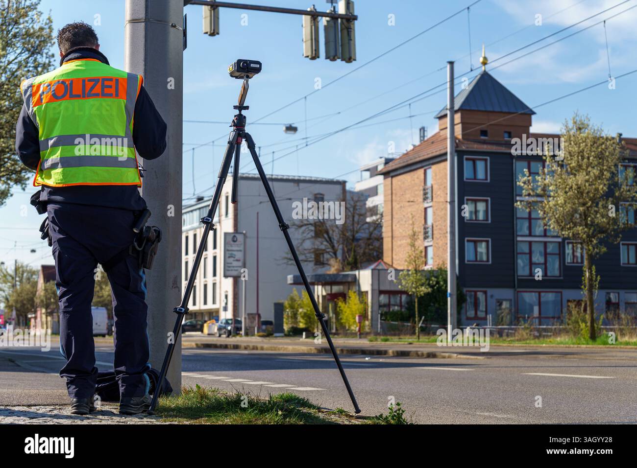 Augsburg, Bavaria, Germany - April 9, 2025: Police officer monitors ...