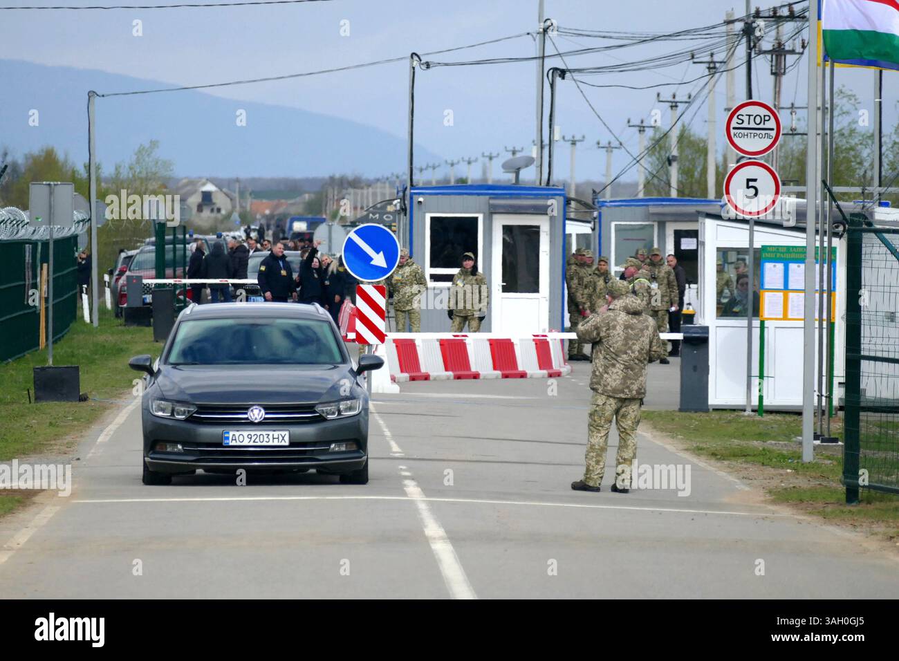 A Ukrainian border guard stands by a car at the Velyka Palad-Nagyhodos ...