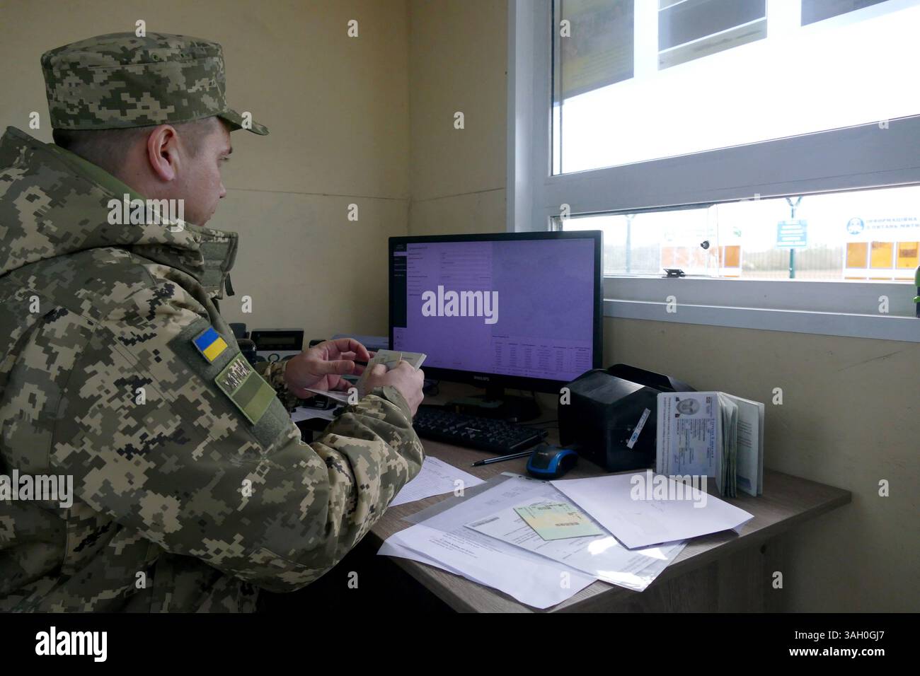 A Ukrainian border guard checks documents at the Velyka Palad-Nagyhodos ...