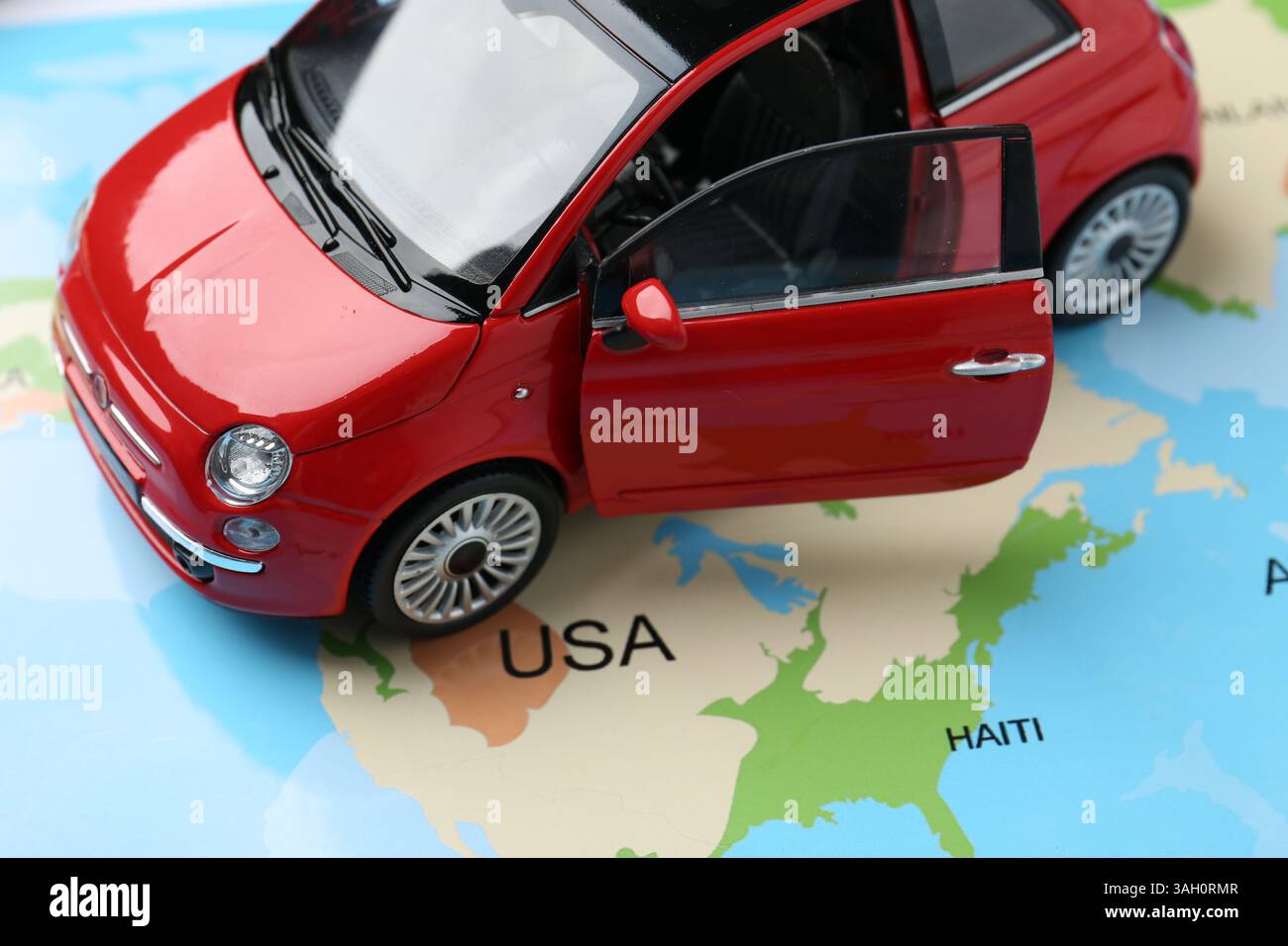 Road trip concept. Car model on world map, closeup Stock Photo - Alamy