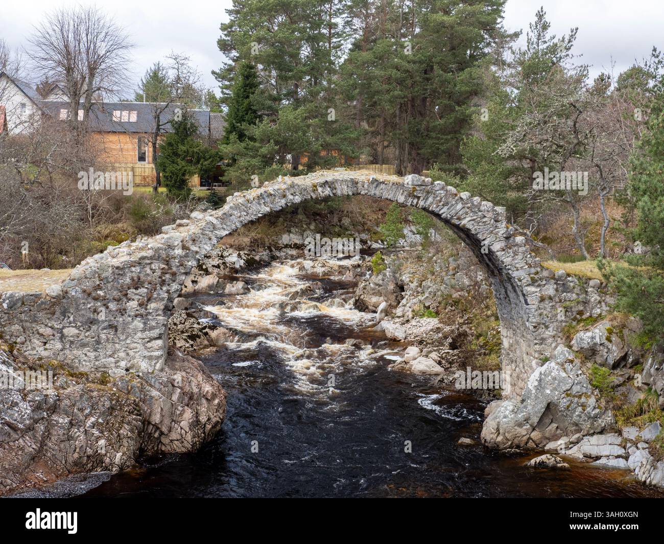 An ancient bridge in Carrbridge in the Cairngorms National Park ...