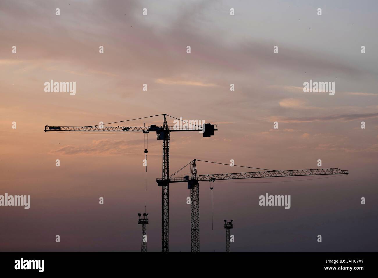 Construction cranes in Lisbon, at dawn, Wednesday, April 9, 2025. (AP ...