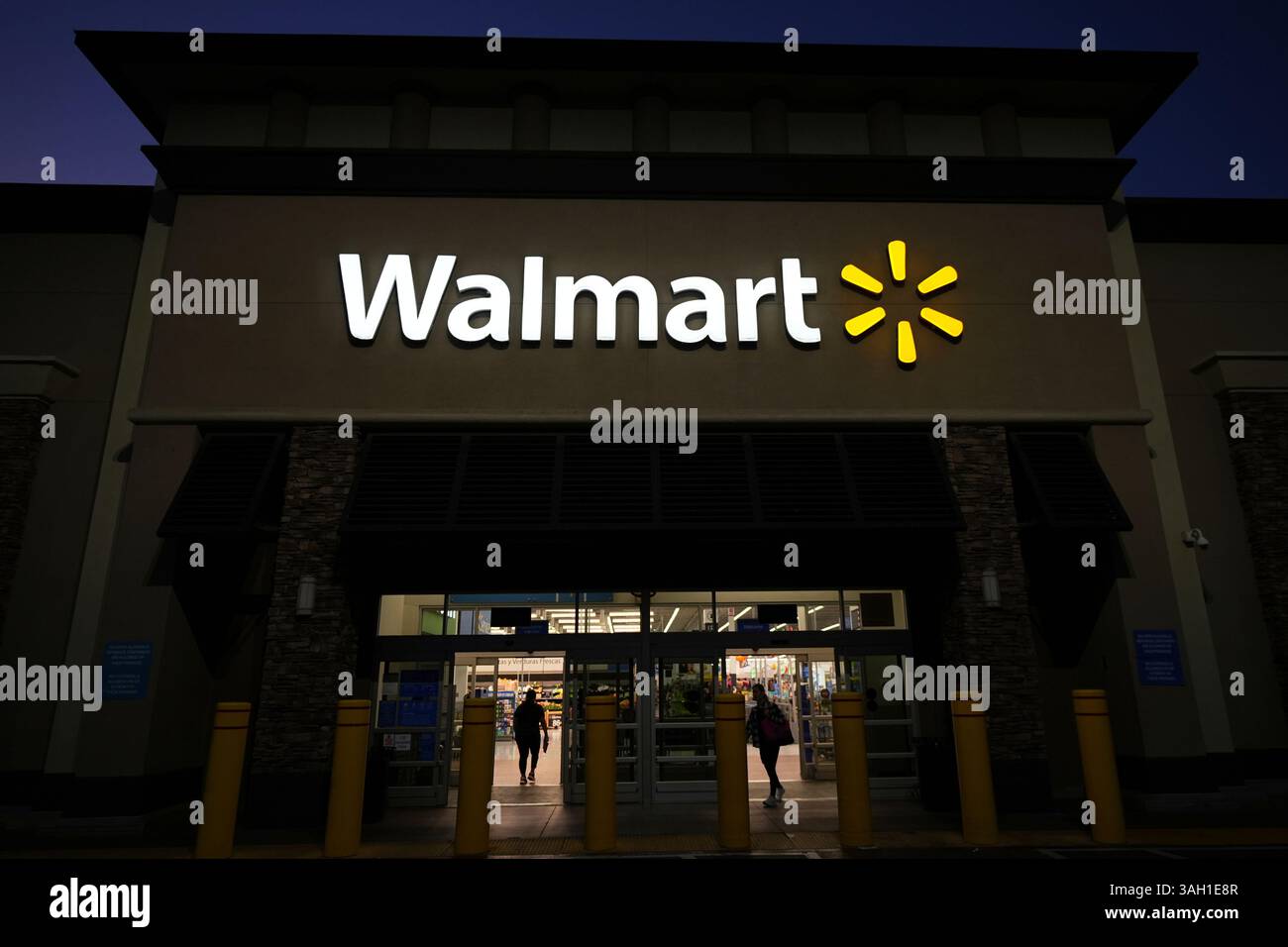 Shoppers enter a Walmart store in La Habra, Calif., Wednesday, April 9 ...