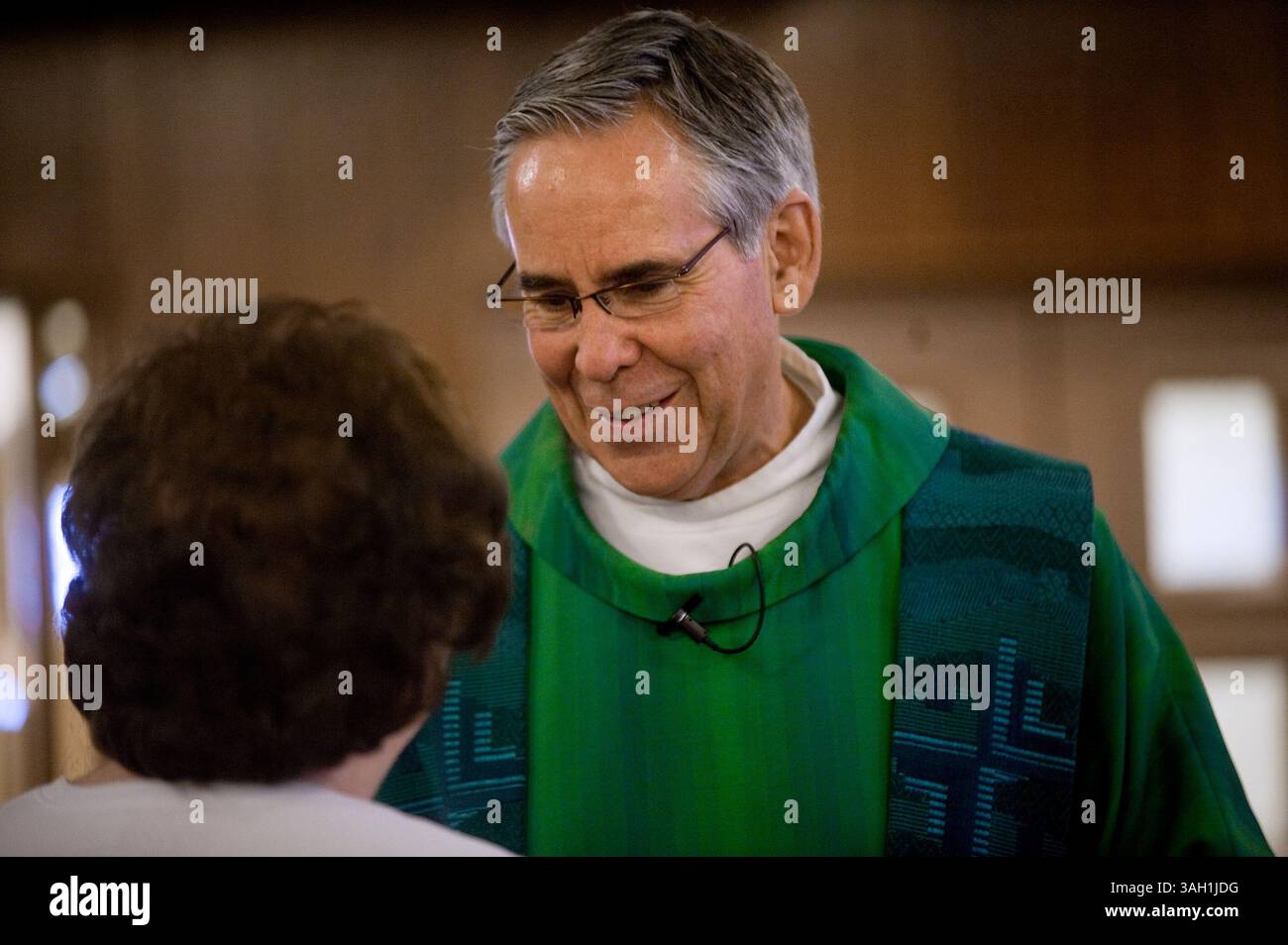 Father Gerry Ryle greets parishioners following a Mass at St. Philomene ...