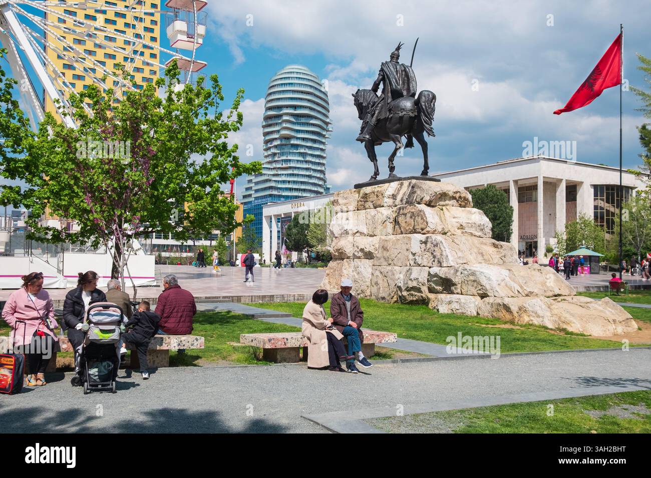 People sitting in the central park by the Monument of Skanderbeg in ...