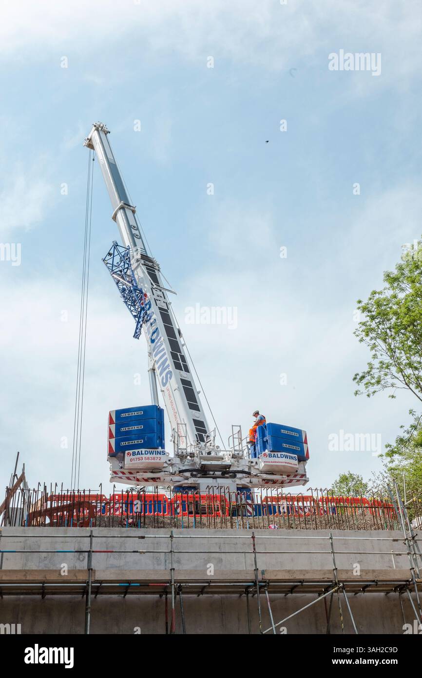 A heavy-lift Baldwins crane lifting concrete beams into place on a new ...