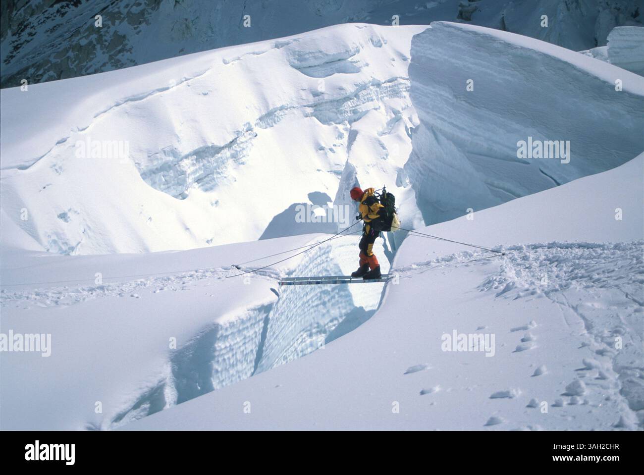 May 22, 2000 - Mount Everest, Nepal - Trekker crossing a ladder in ...