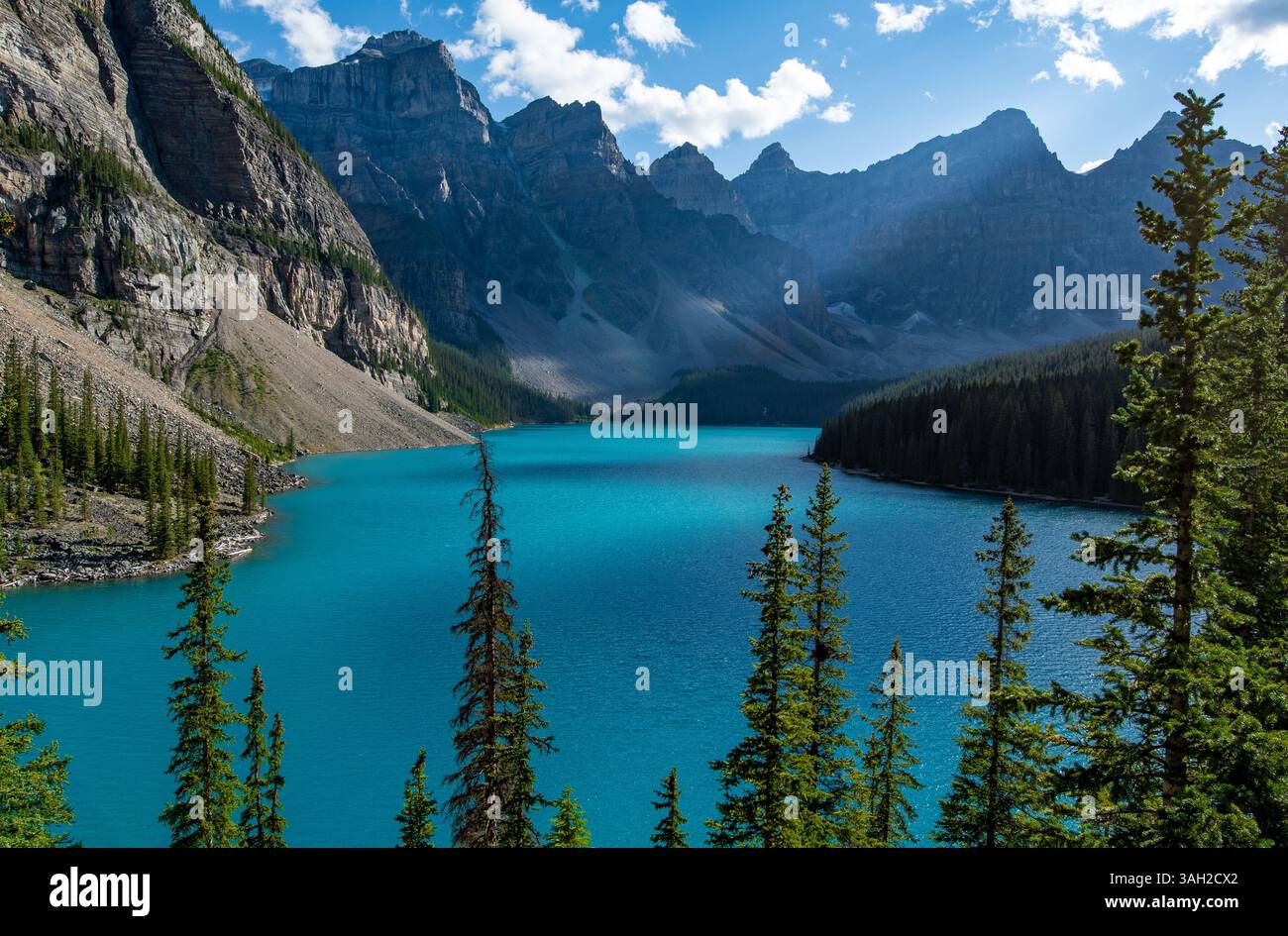 Moraine Lake and the Valley of the Ten Peaks in Banff, Canada at sunset with sunlight shining ...