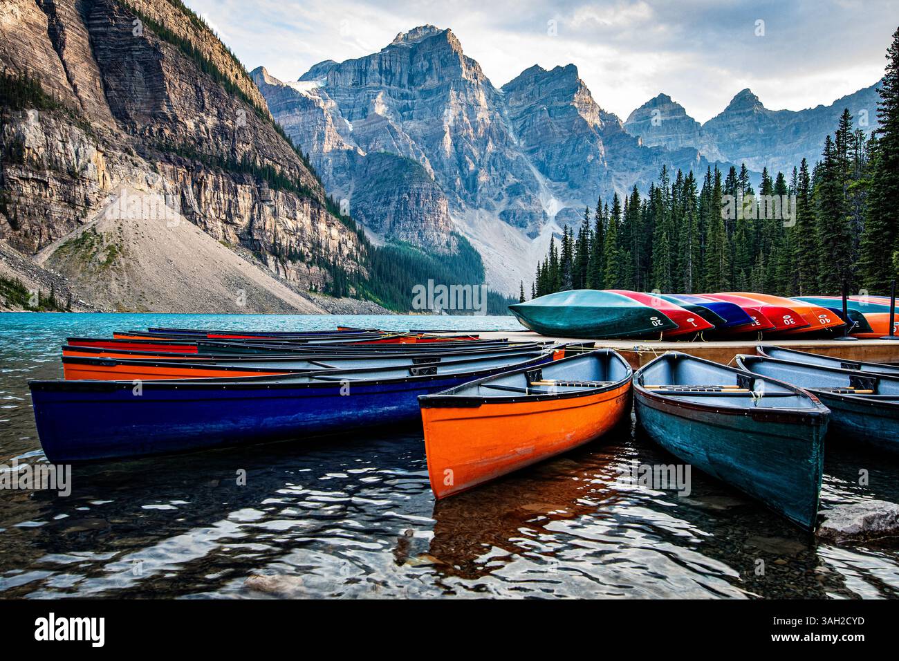 Moraine Lake and the Valley of the Ten Peaks in Banff, Canada at sunset with sunlight shining ...