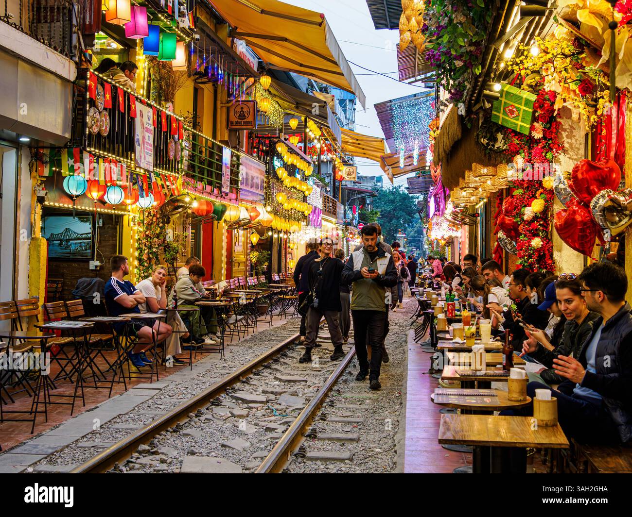 Sidewalk restaurants line Train Street, Hanoi, Vietnam Stock Photo - Alamy