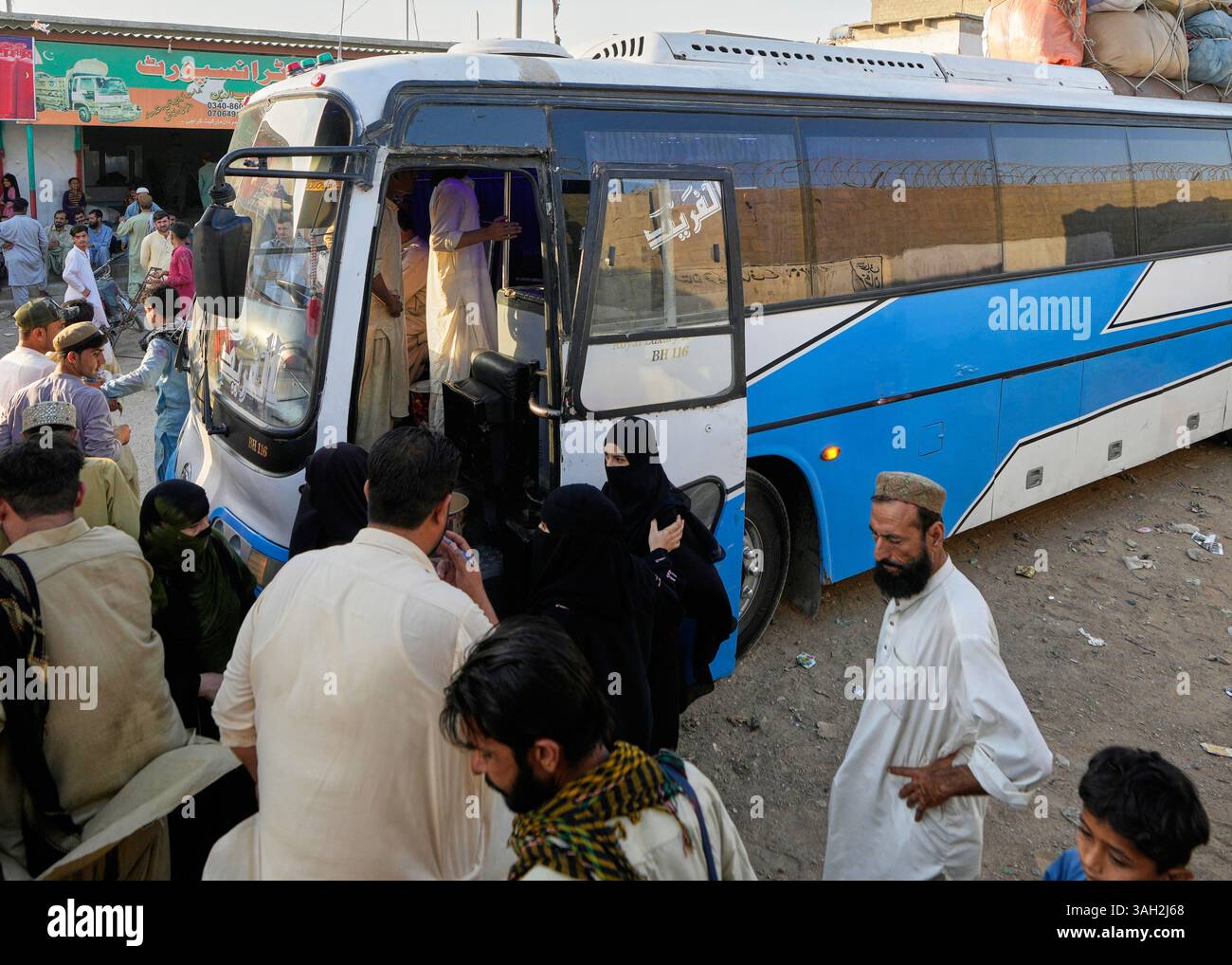 Afghan refugees board a bus to leave for their homeland Afghanistan, at ...