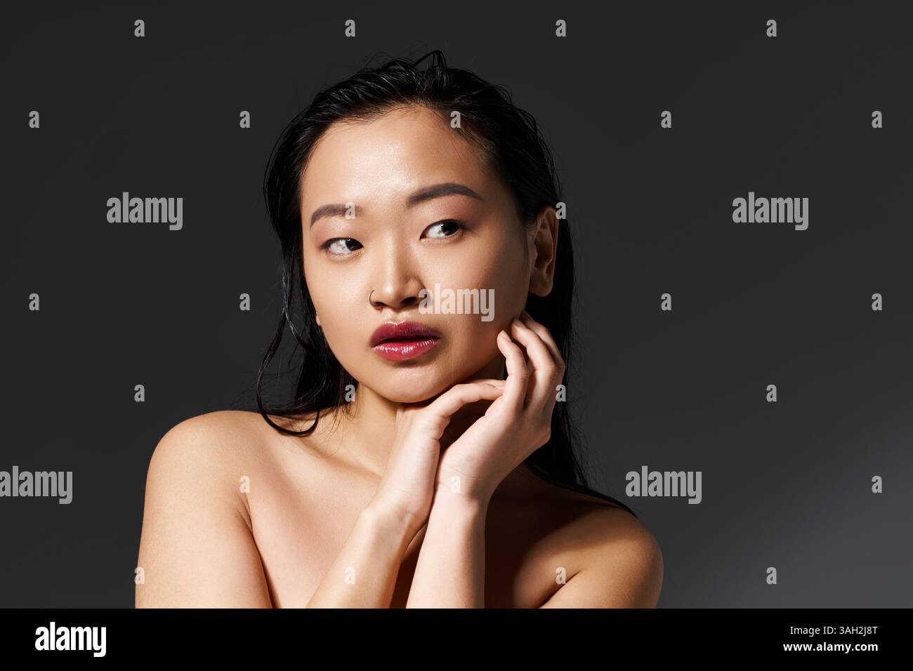 A beautiful young Asian woman poses gracefully, highlighting her ...