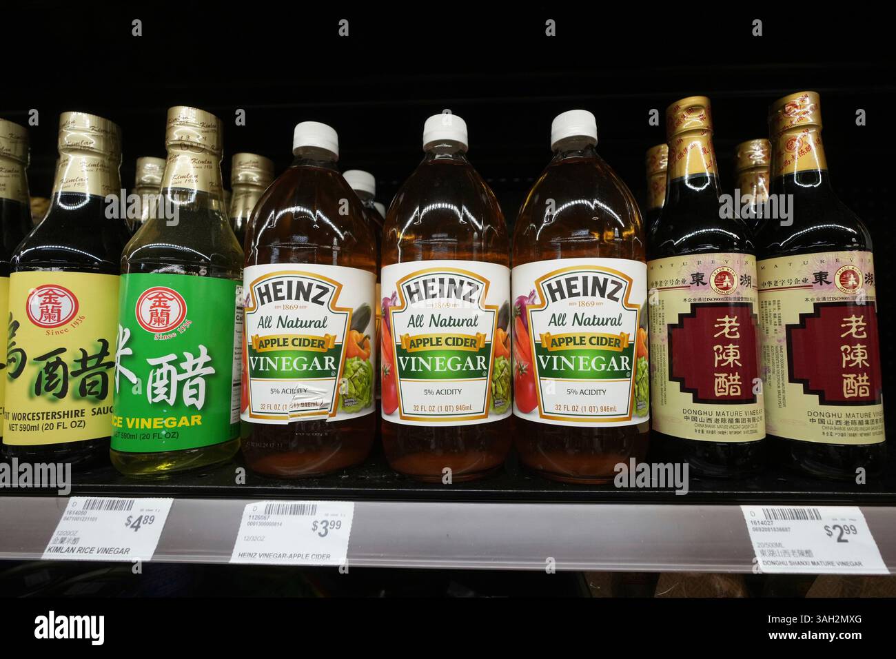 Bottles of Mature Donghu vinegar imported from China, right, sit next to Heinz US made All ...