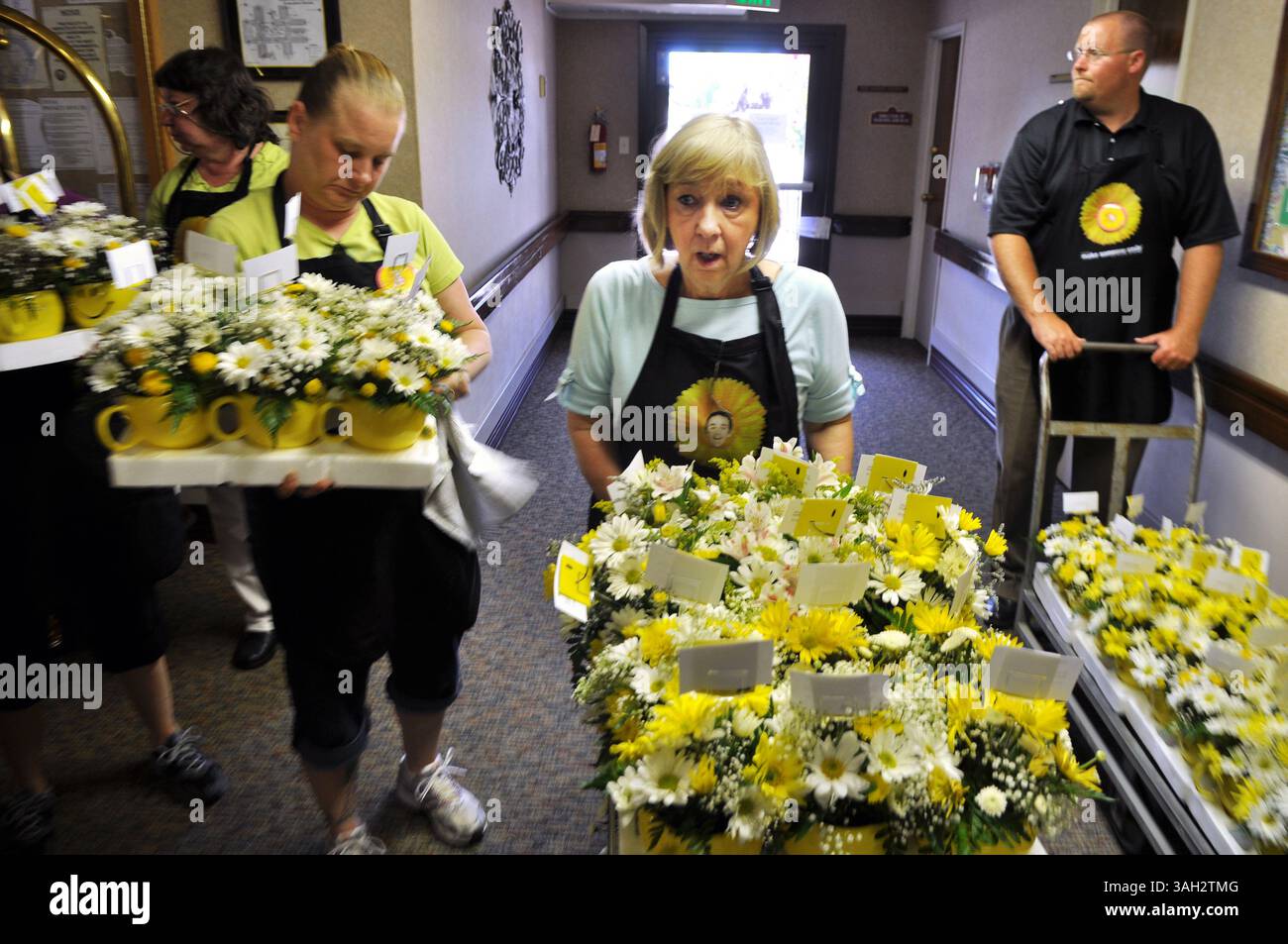Florist Karen Genoud, middle, seen with her staff delivering flower bouquets at Roseville Care ...