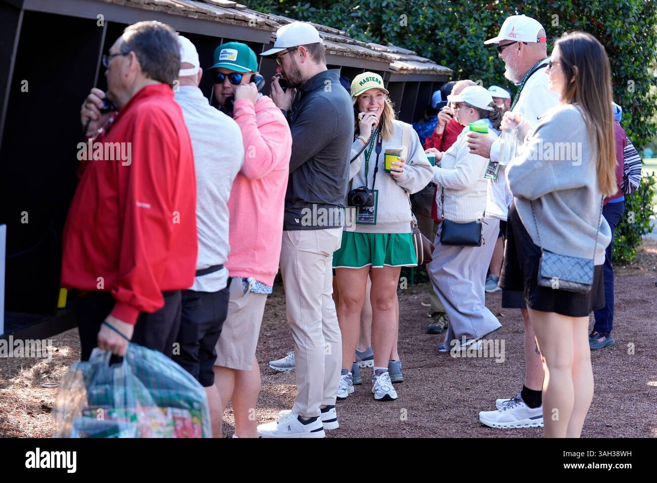 Patrons line up to use courtesy phones during a practice around at the ...