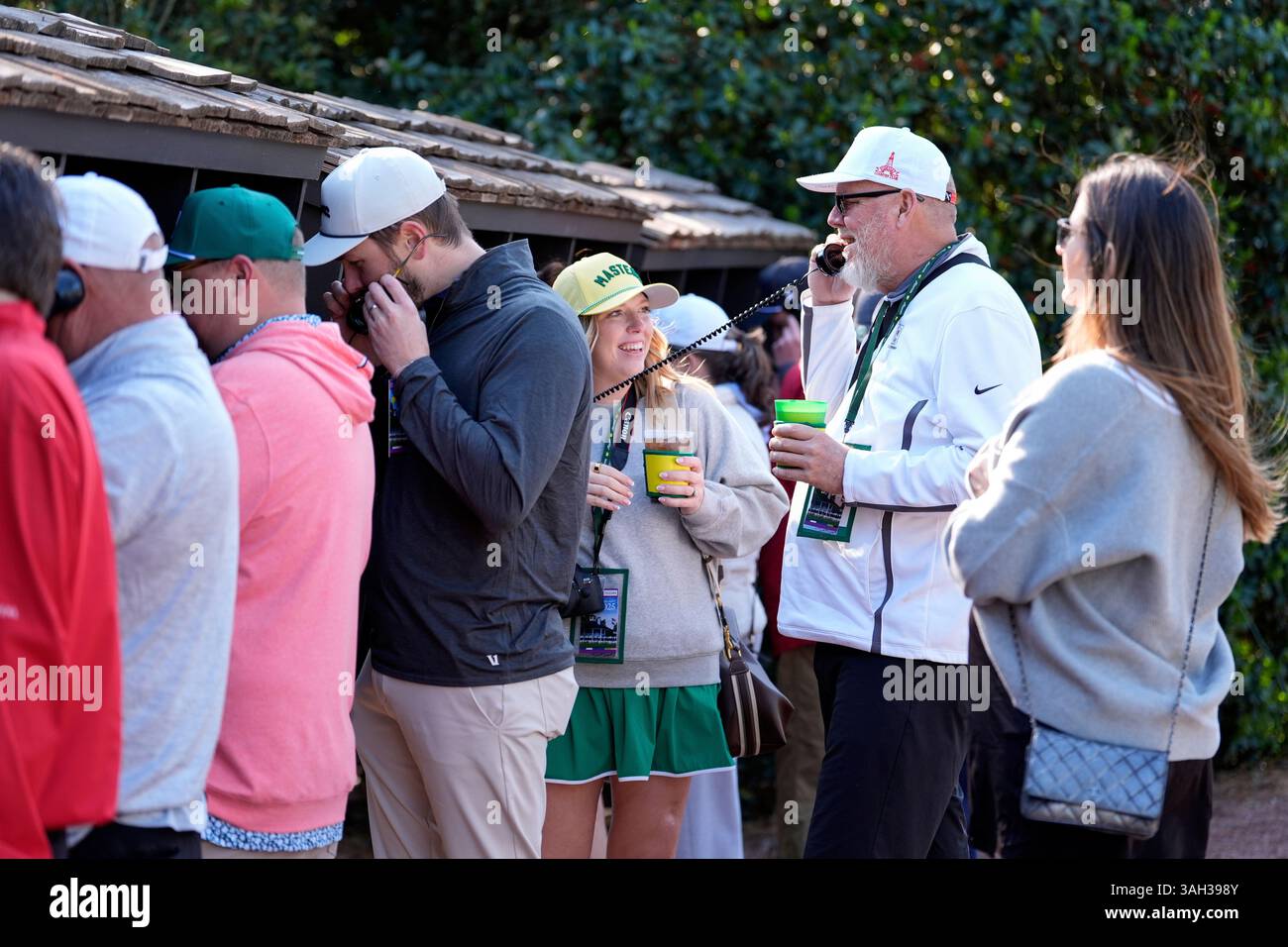 Patrons line up to use courtesy phones during a practice around at the ...