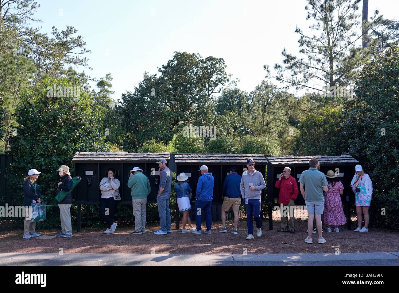 Patrons line up to use courtesy phones during a practice around at the ...