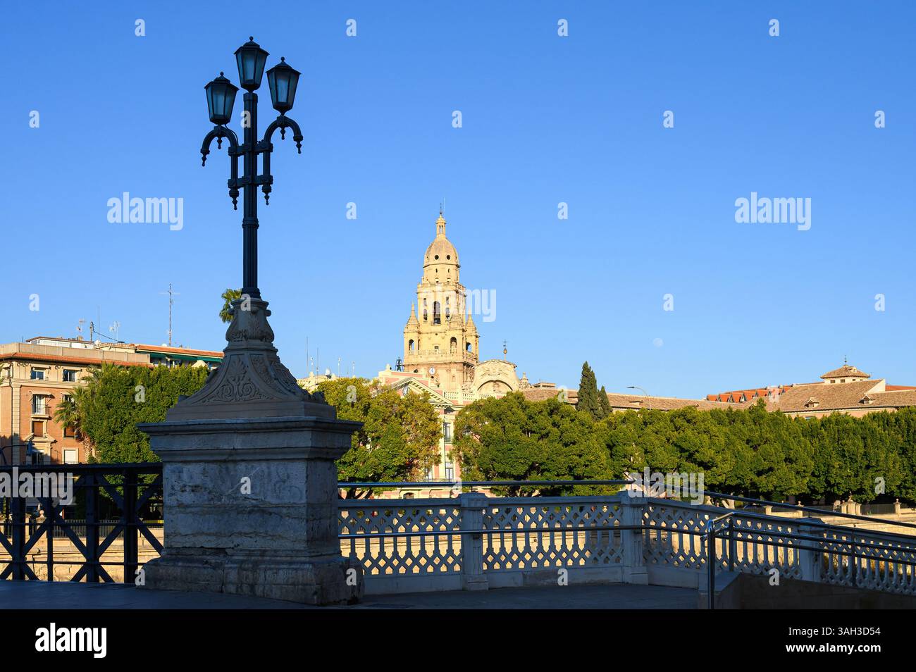 Old-fashioned street light framing the medieval steeple of the ...