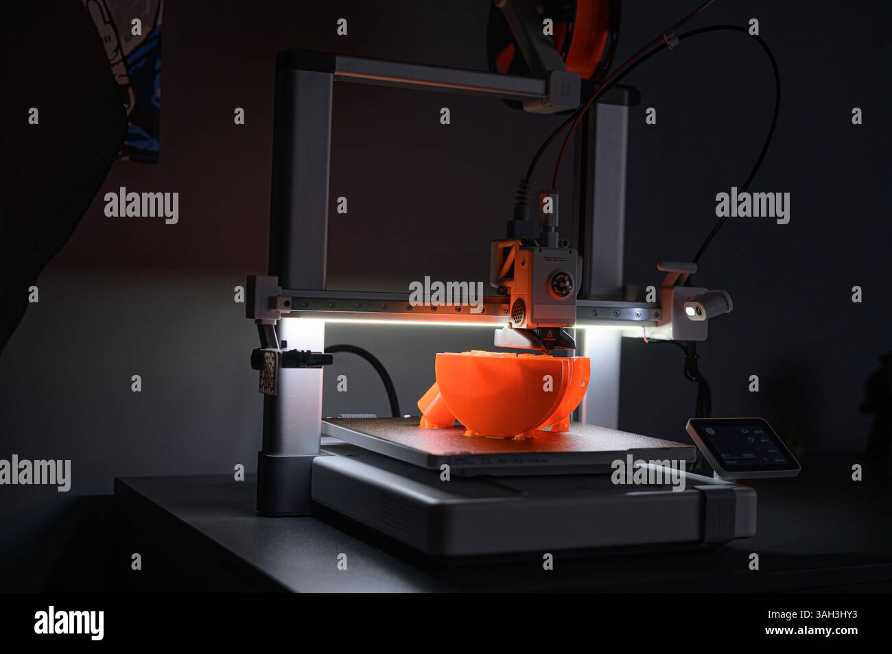 3D Printer Creating Orange Plastic Object on Platform Stock Photo - Alamy
