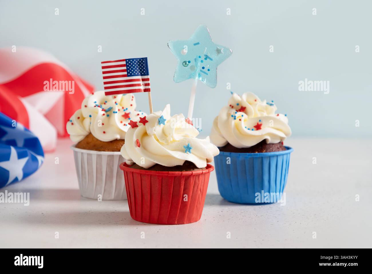 Traditional American three sweet cupcakes in white plate and USA flag ...