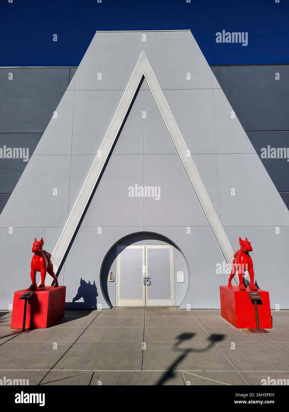 Geometric Facade with Red Dog Statues in Urban Setting Eye Level View ...