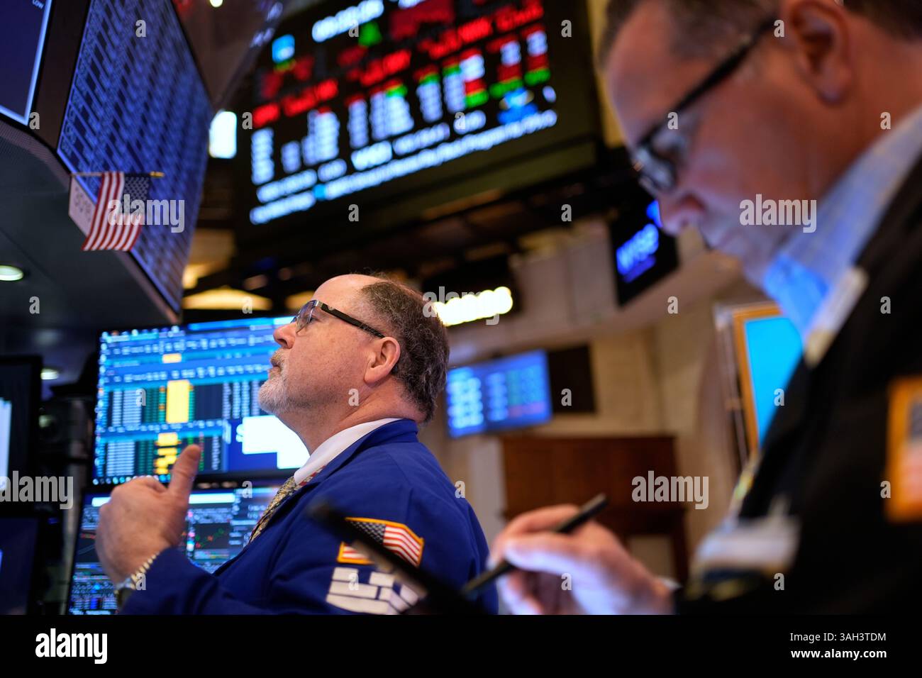 Traders work on the floor at the New York Stock Exchange in New York ...