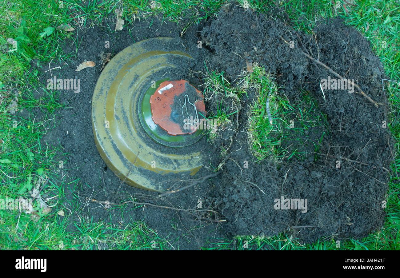 Green anti tank mine on the grass in the ground. Bomb TM-62 Stock Photo ...