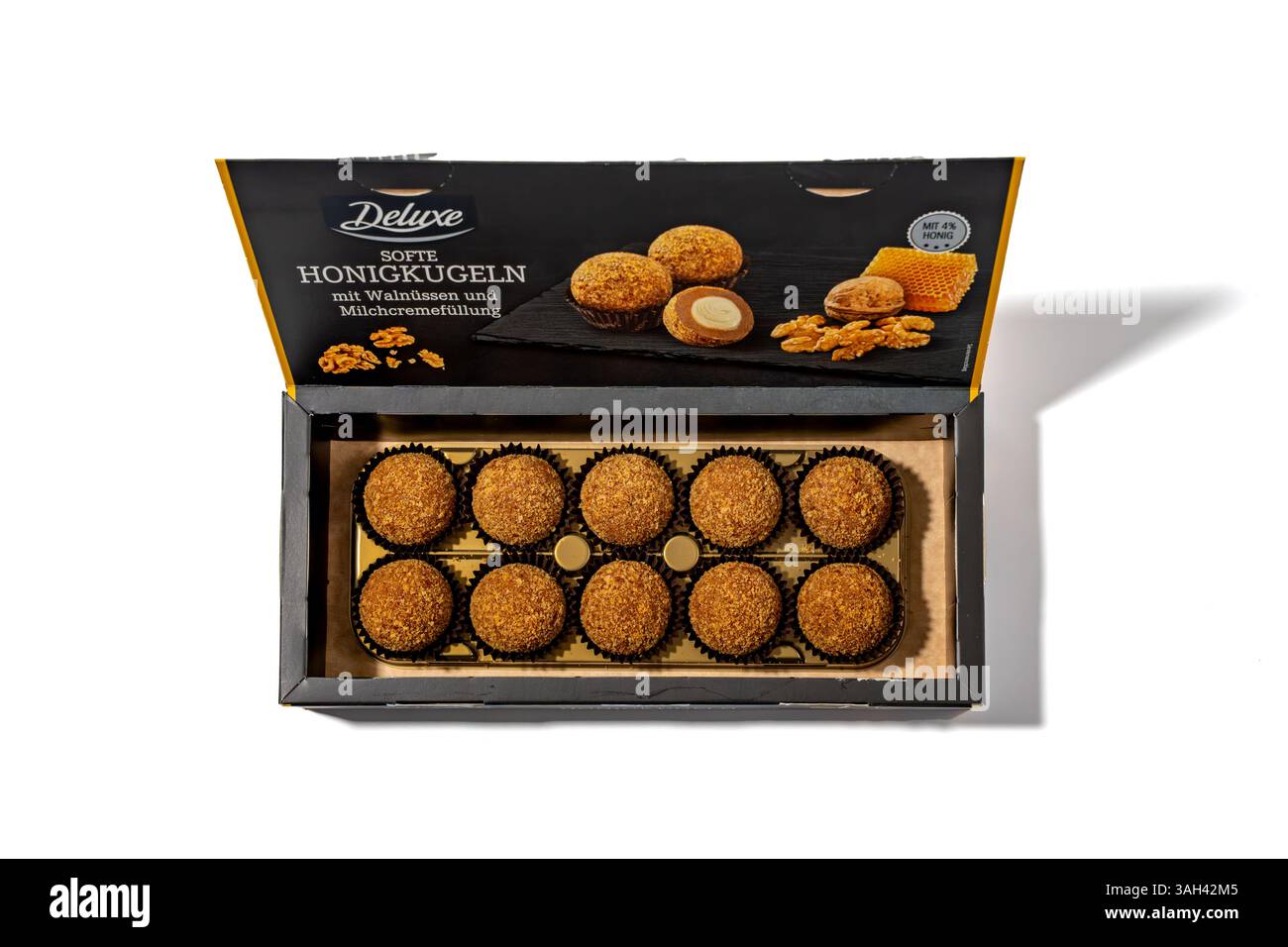 Germany Berlin April 9, 2025. Black box of honey balls candies isolated ...