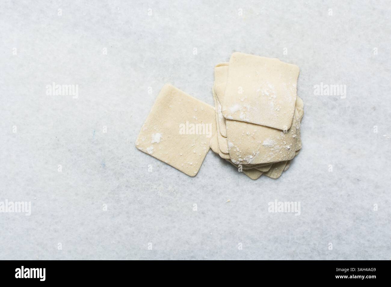 Overhead view of dumpling wrappers dough being cut, process of making ...