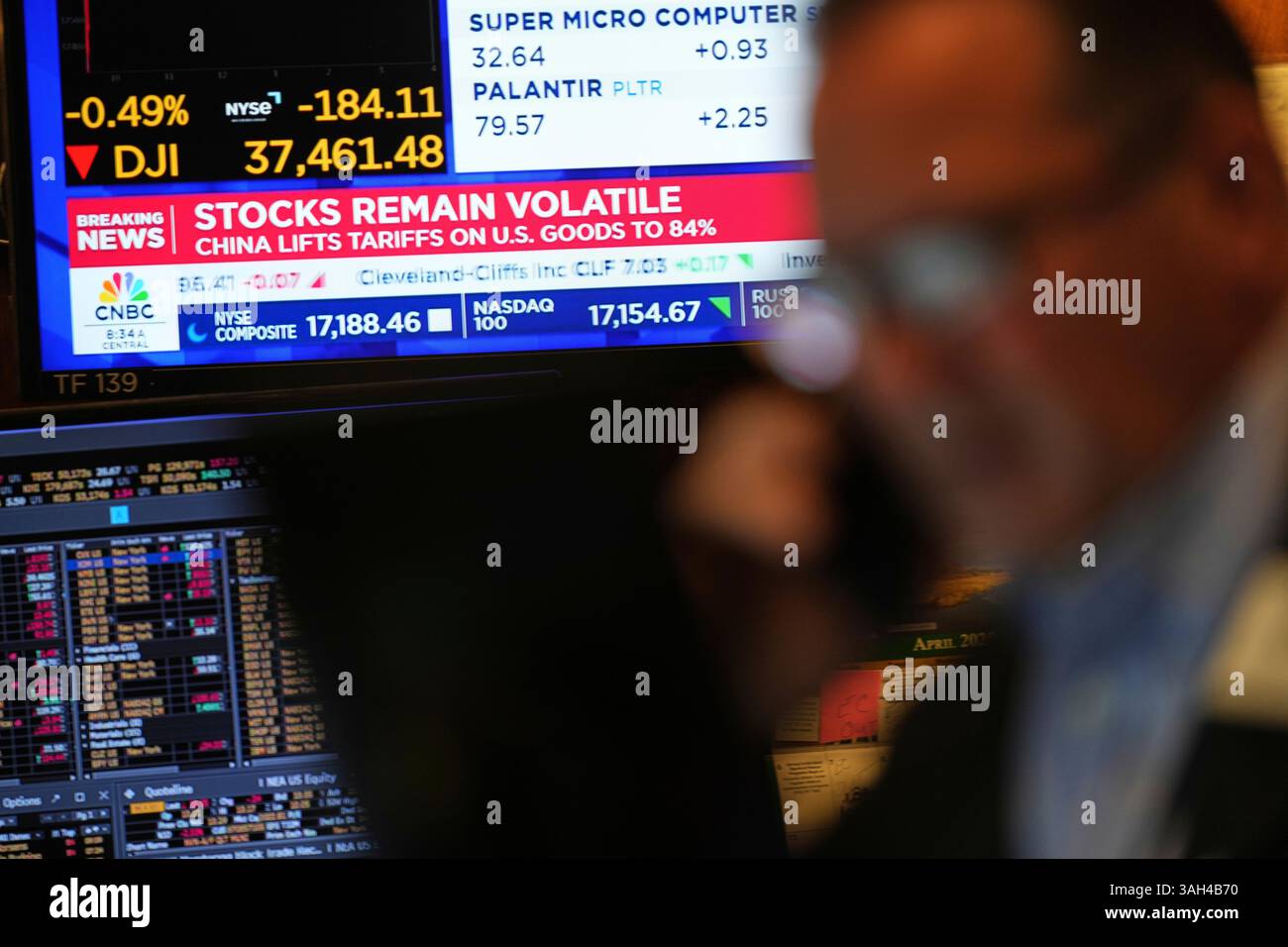 A television displays financial news on the floor at the New York Stock ...