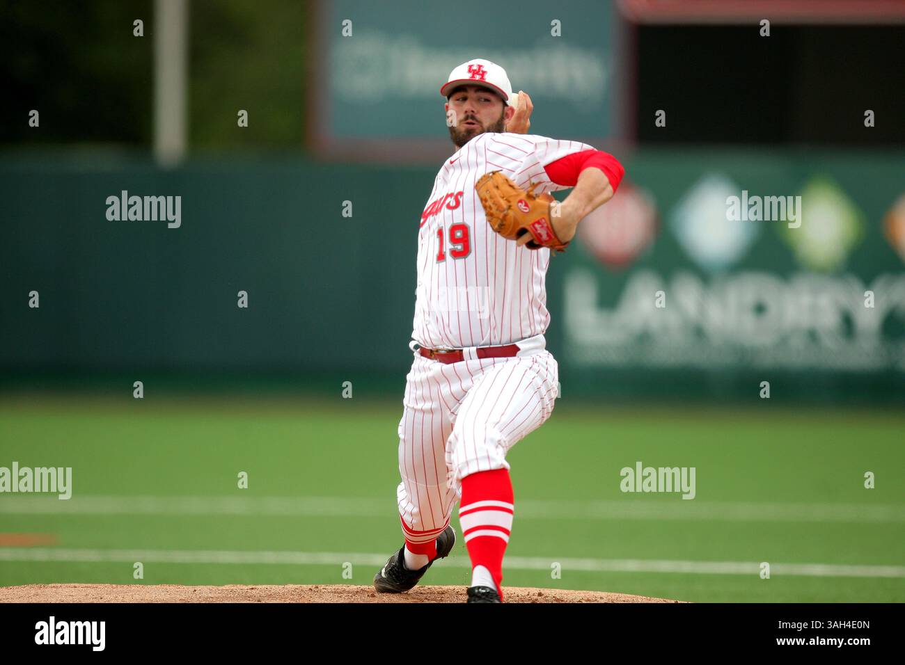 APR 12 2015: Houston pitcher Taylor Cobb #19 reaches back to deliver a ...