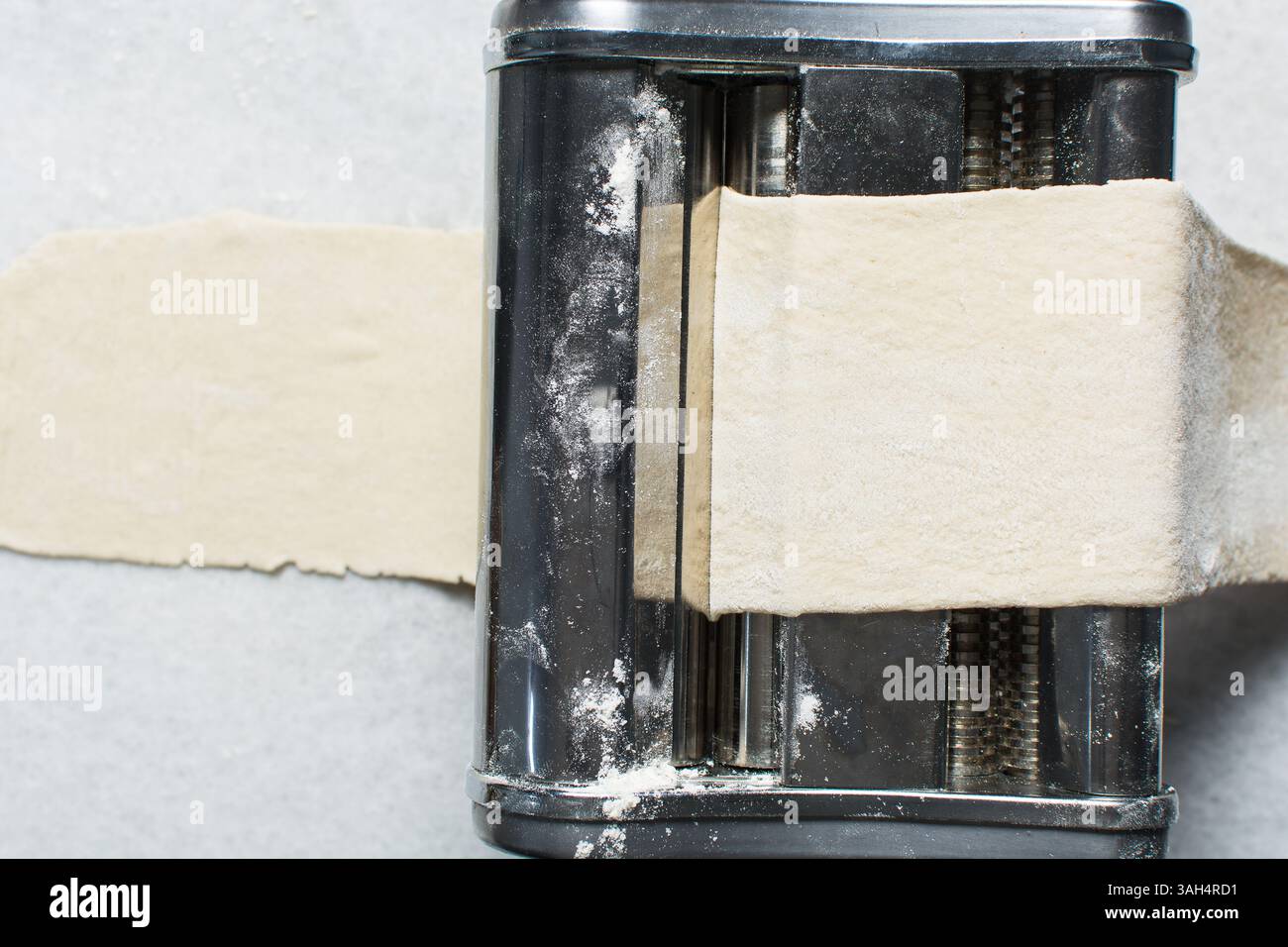 Overhead view of dumpling wrappers dough being rolled out, process of ...