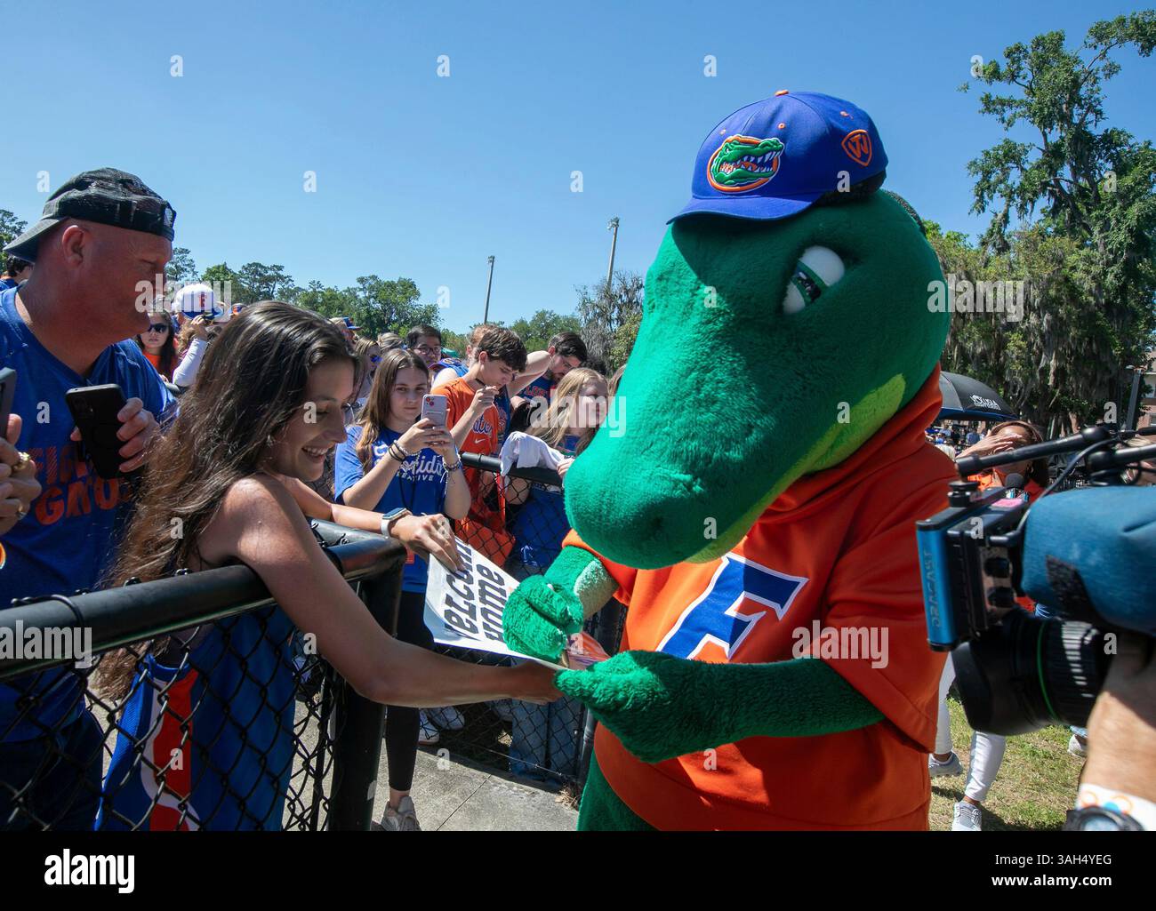 Florida mascot Albert signs a poster for Rhiannon O'Donnell as the team ...