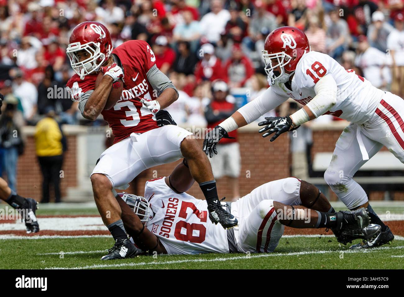 April 11, 2105: Oklahoma Sooners running back Daniel Brooks (34) is tackled by defensive end D.J ...
