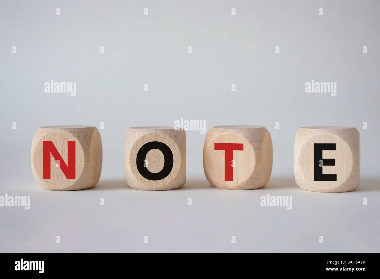 Note symbol. Concept word Note on wooden cubes. Beautiful white ...