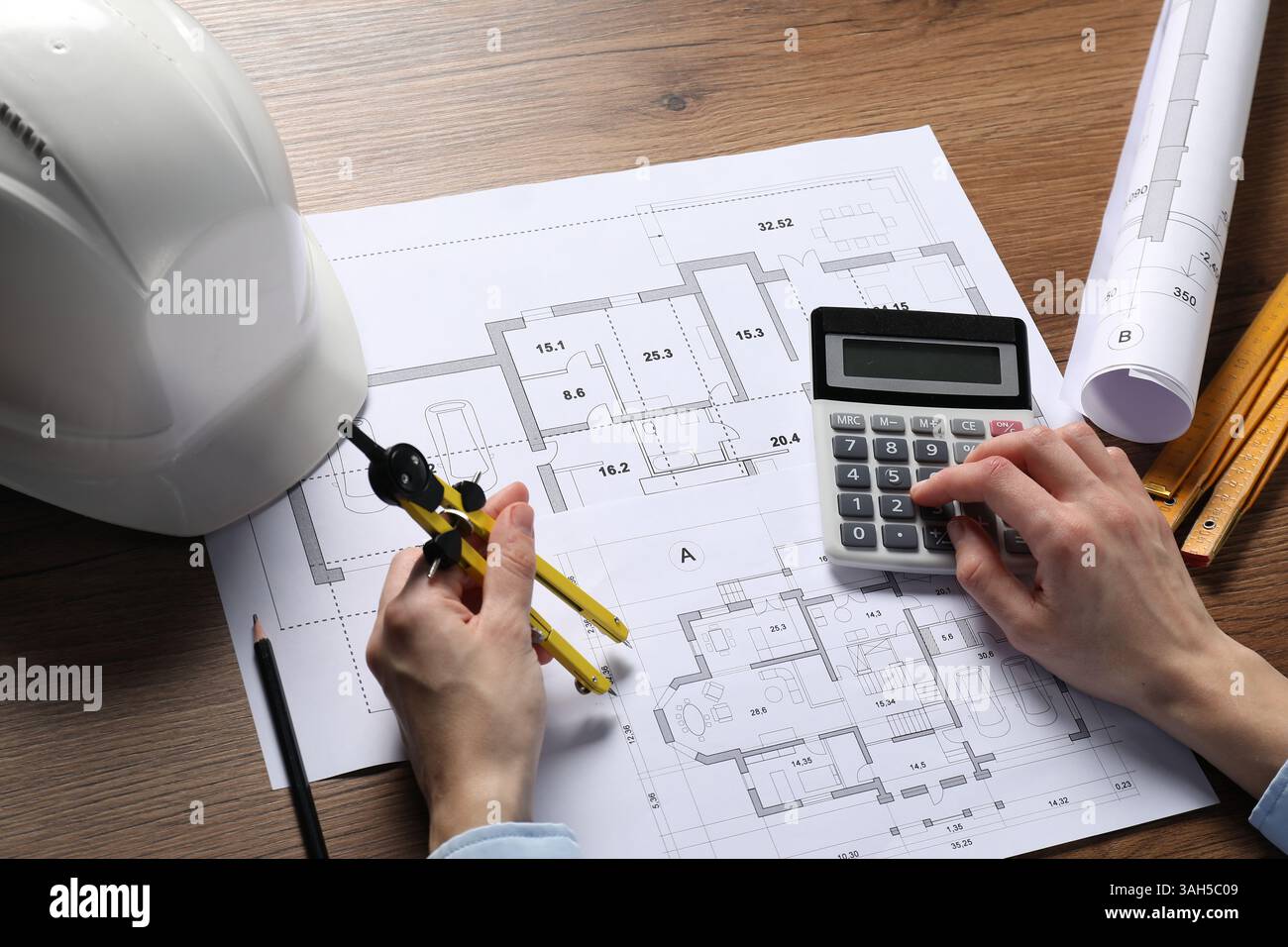 Architect working with project, closeup. Different technical drawings and construction tools on ...